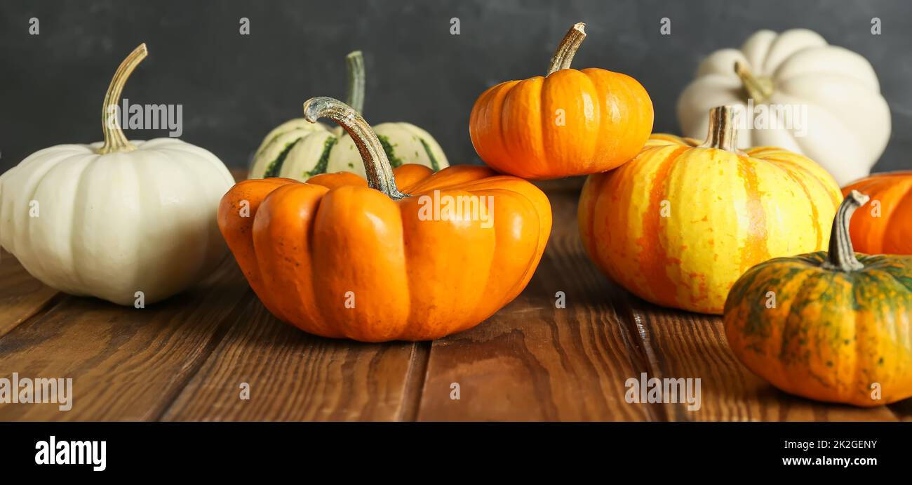 Halloween pumpkins on wooden table against dark background Stock Photo ...