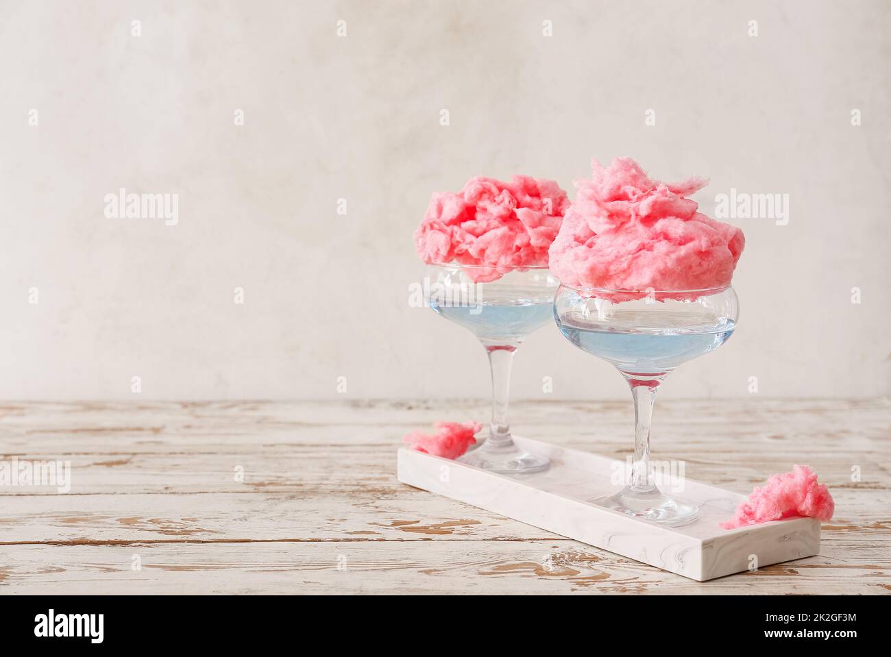Glasses with tasty cotton candy cocktail on light wooden table Stock ...