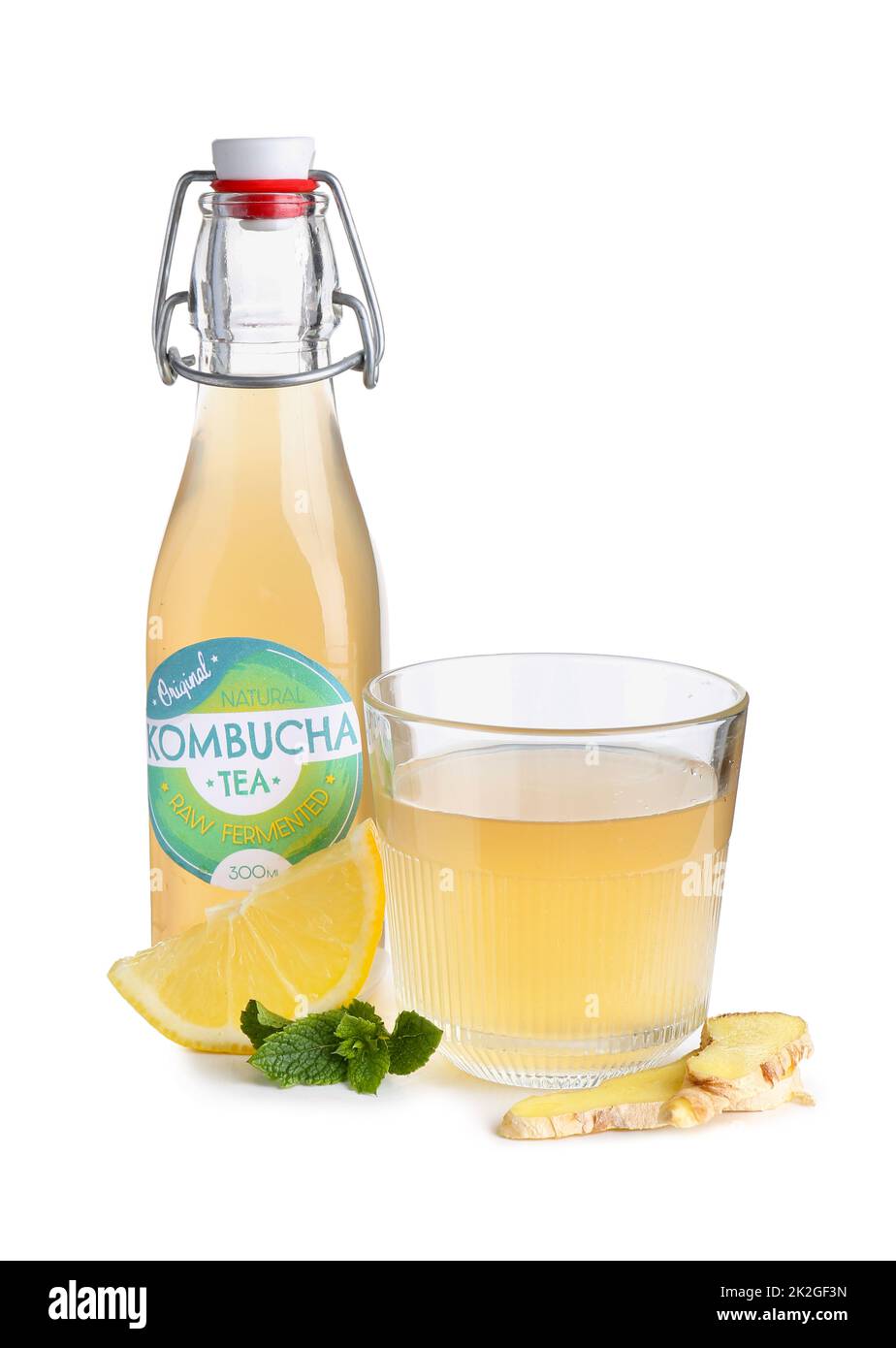 Bottle of natural kombucha tea with ginger and lemon on white ...