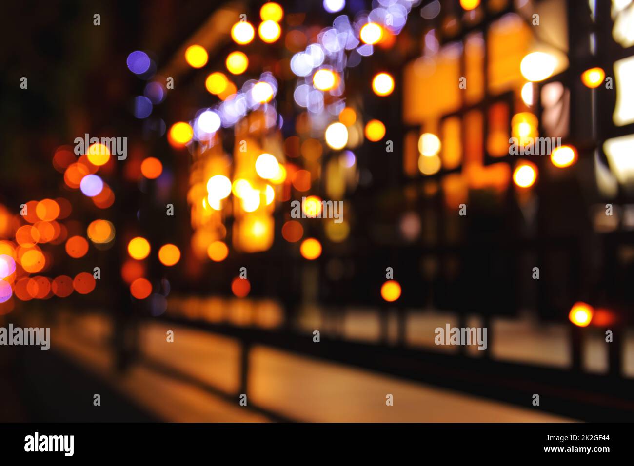 Blurred view of building with glowing lights at night Stock Photo - Alamy