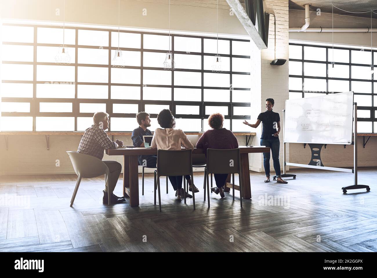 Coming together is a beginning. Shot of a group of colleagues having an ...