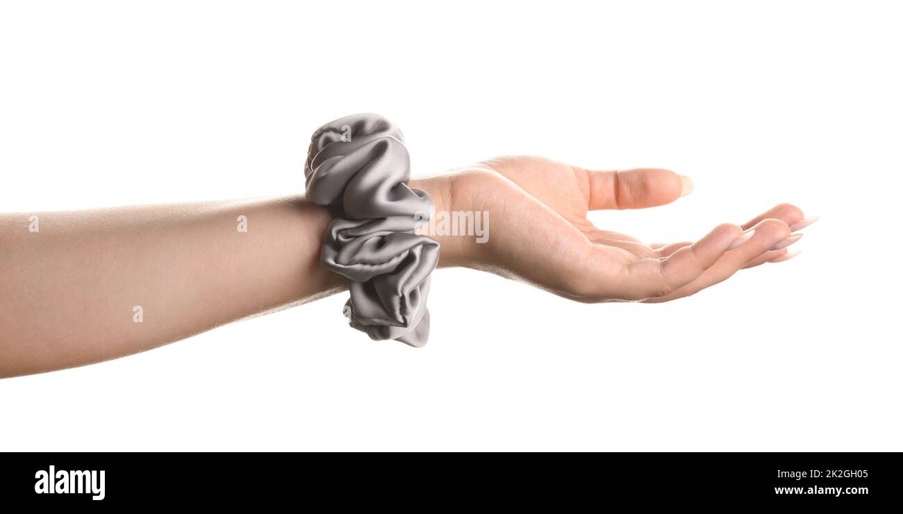 Female hand with silk scrunchy on white background Stock Photo - Alamy