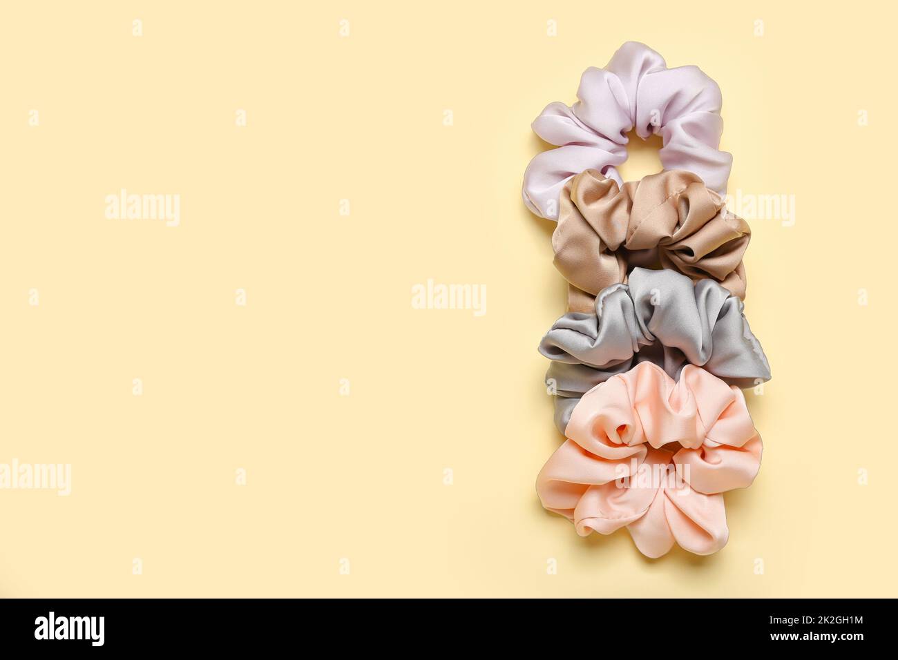 Different silk scrunches on color background Stock Photo - Alamy