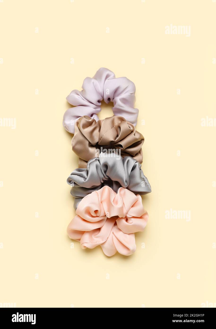 Different silk scrunches on color background Stock Photo - Alamy