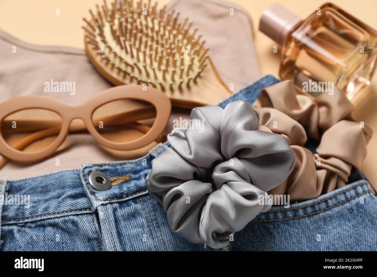 Stylish female clothes and accessories on beige background, closeup ...