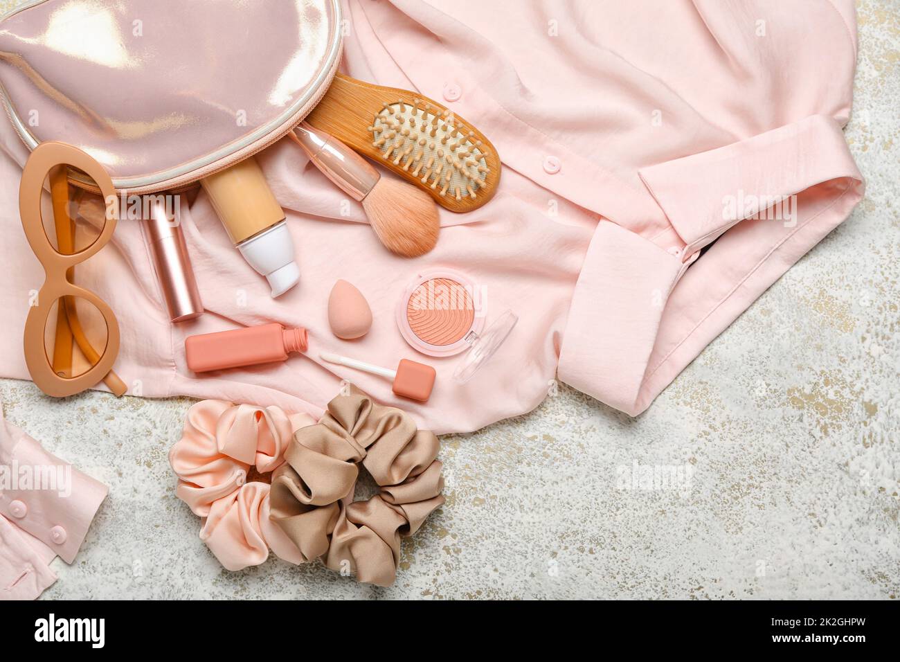 Female shirt, cosmetics and silk scrunchies on light background Stock ...