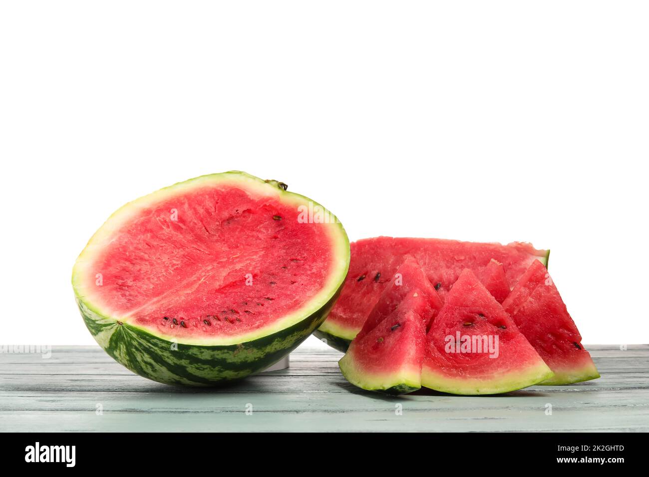 Slices of ripe watermelon on table against white background Stock Photo ...