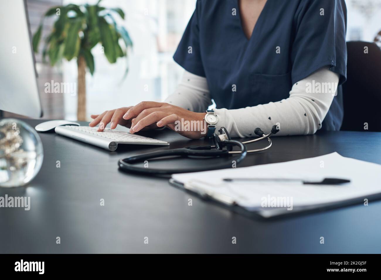 Doctor typing in office hi-res stock photography and images - Alamy