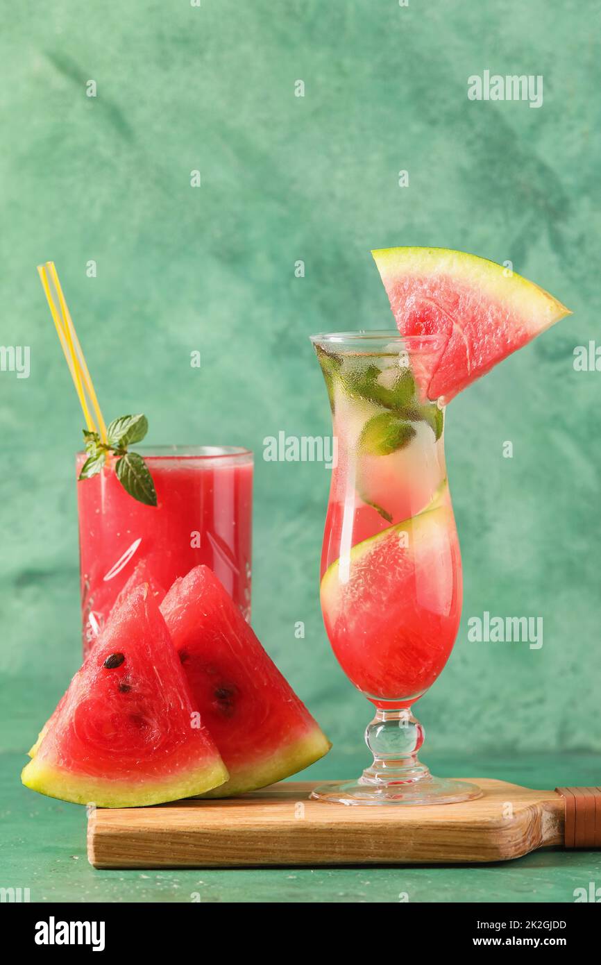 Board with glasses of cold watermelon fresh on green background Stock ...
