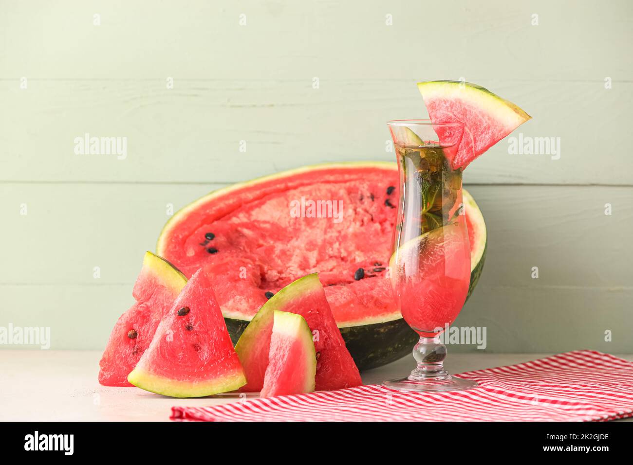 Glass of cold watermelon fresh on table against color wooden background ...