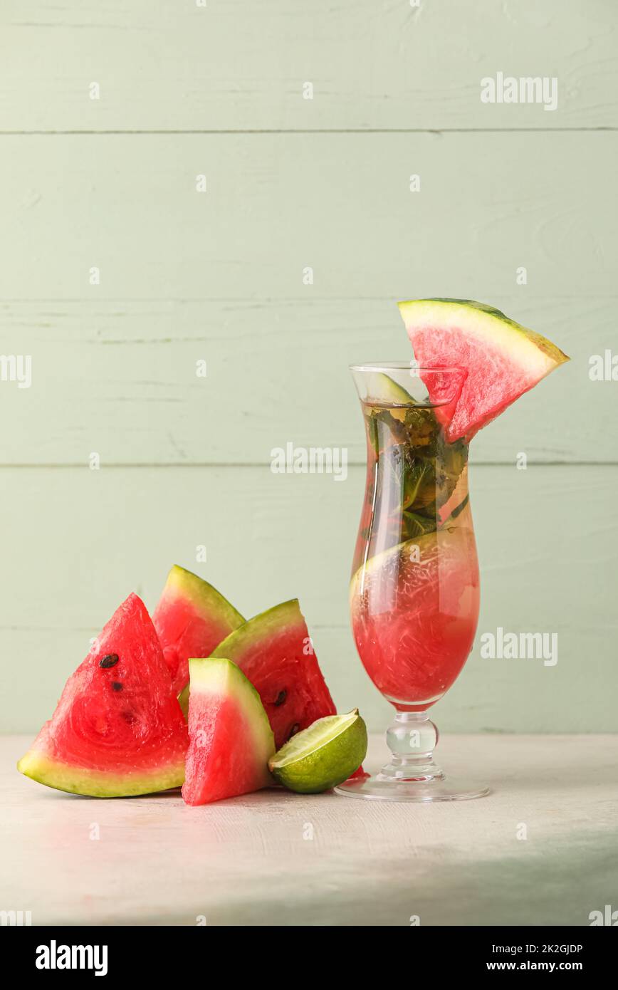 Glass of cold watermelon fresh on table against color wooden background ...