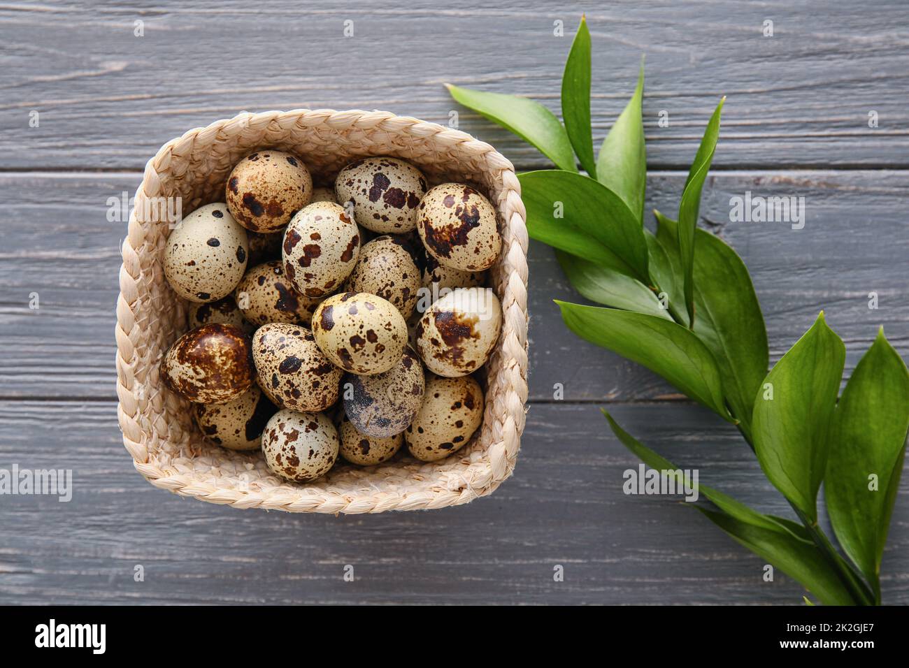 Wicker basket with quail eggs on dark wooden background Stock Photo - Alamy