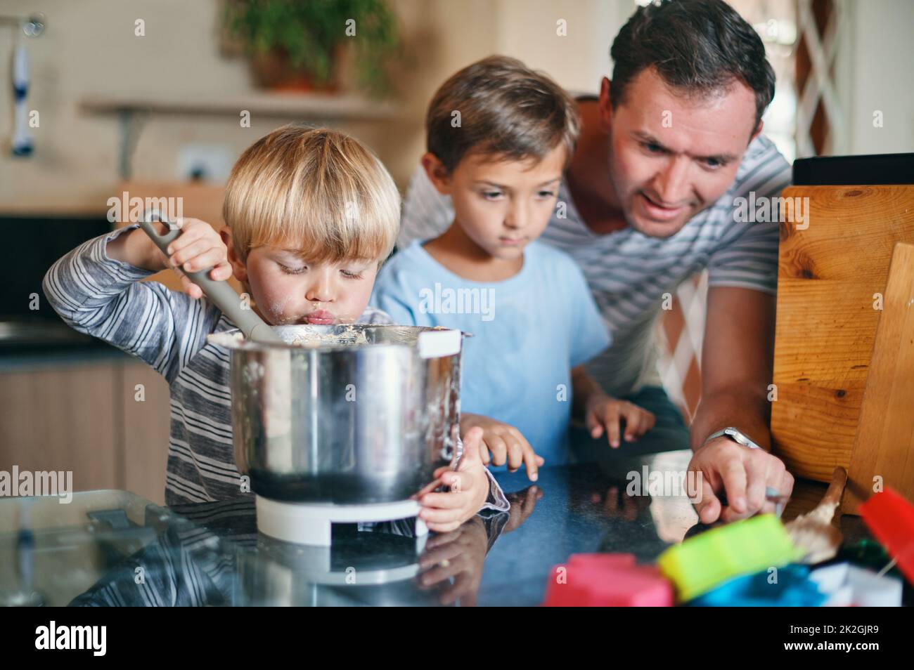 Not just baking, its a time to bond. Shot of a young man baking with ...