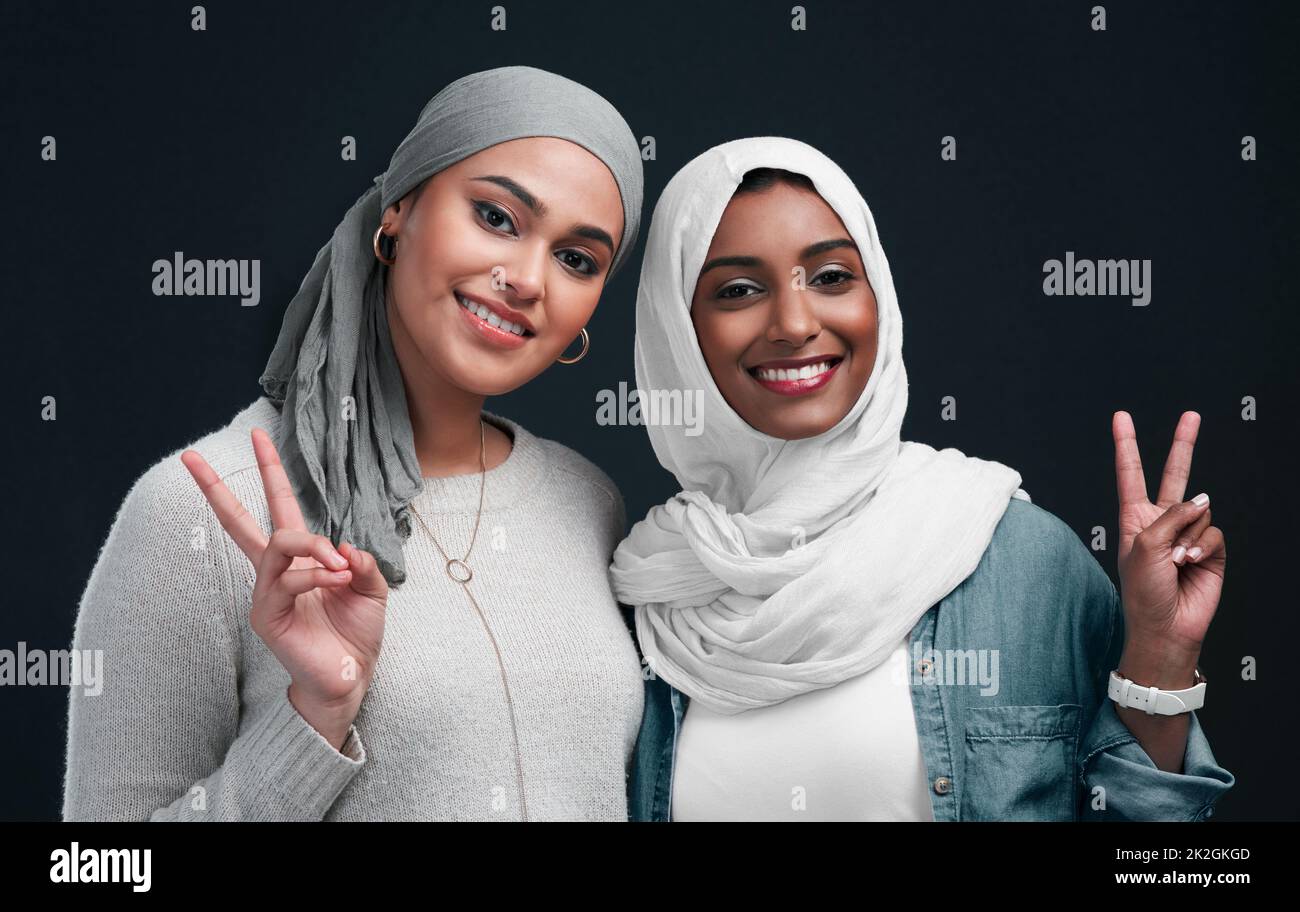Millennial trends. Cropped shot of two attractive young women wearing ...