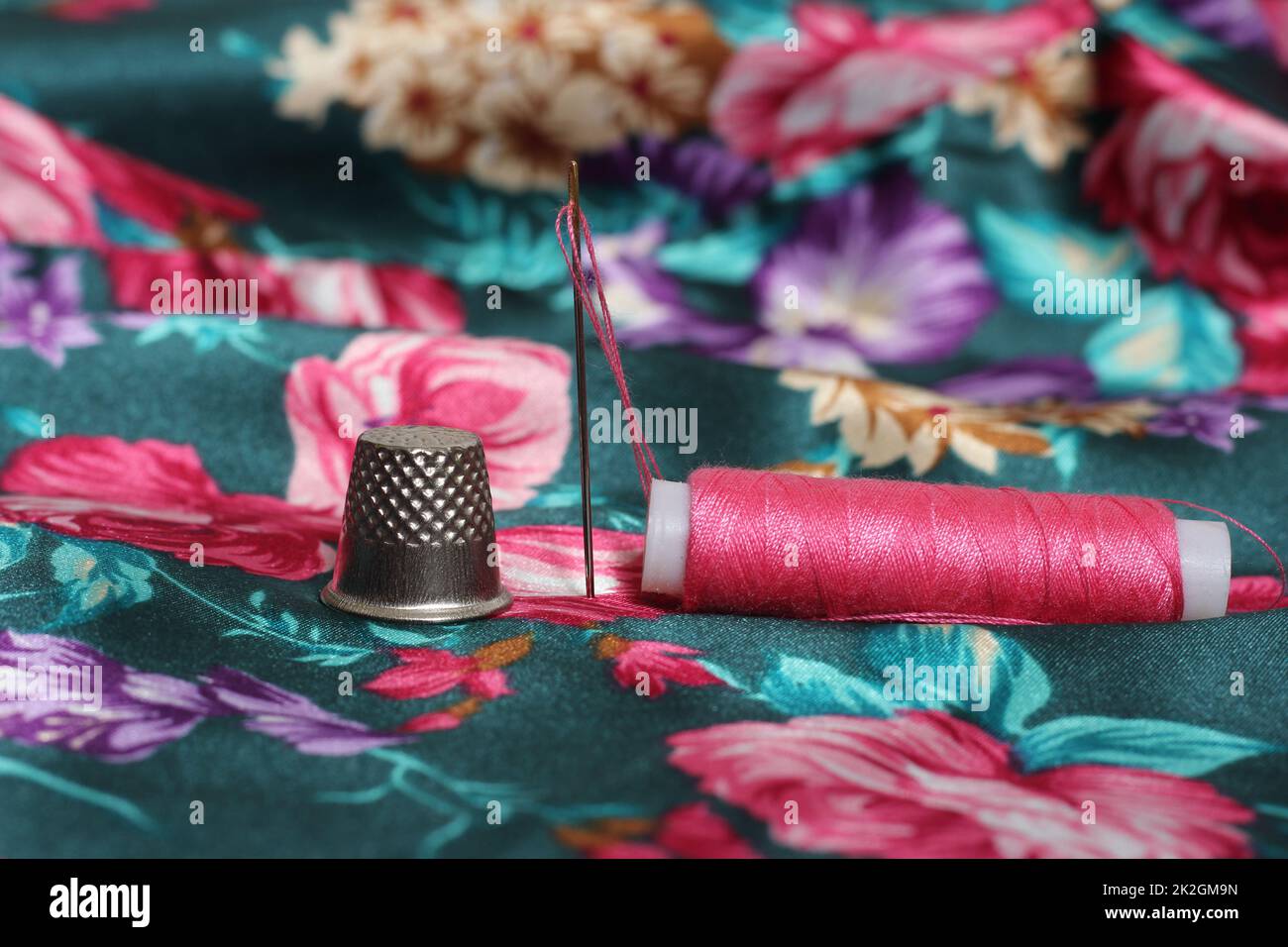 Thimble With Needle and Pink Thread on Vintage Floral Satin Fabric ...