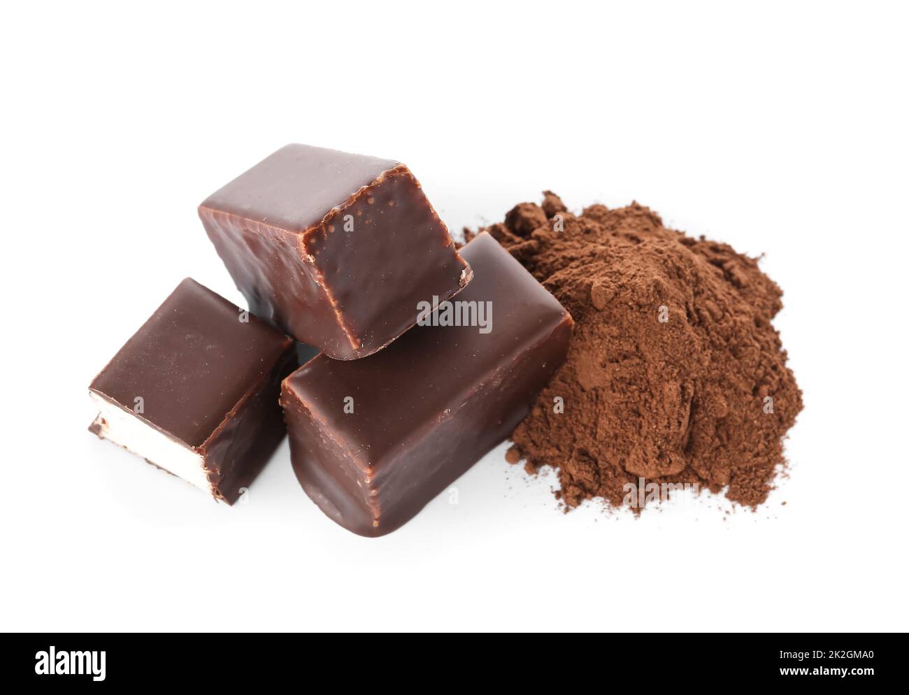 Tasty bird's milk candies and heap of cocoa powder on white background ...