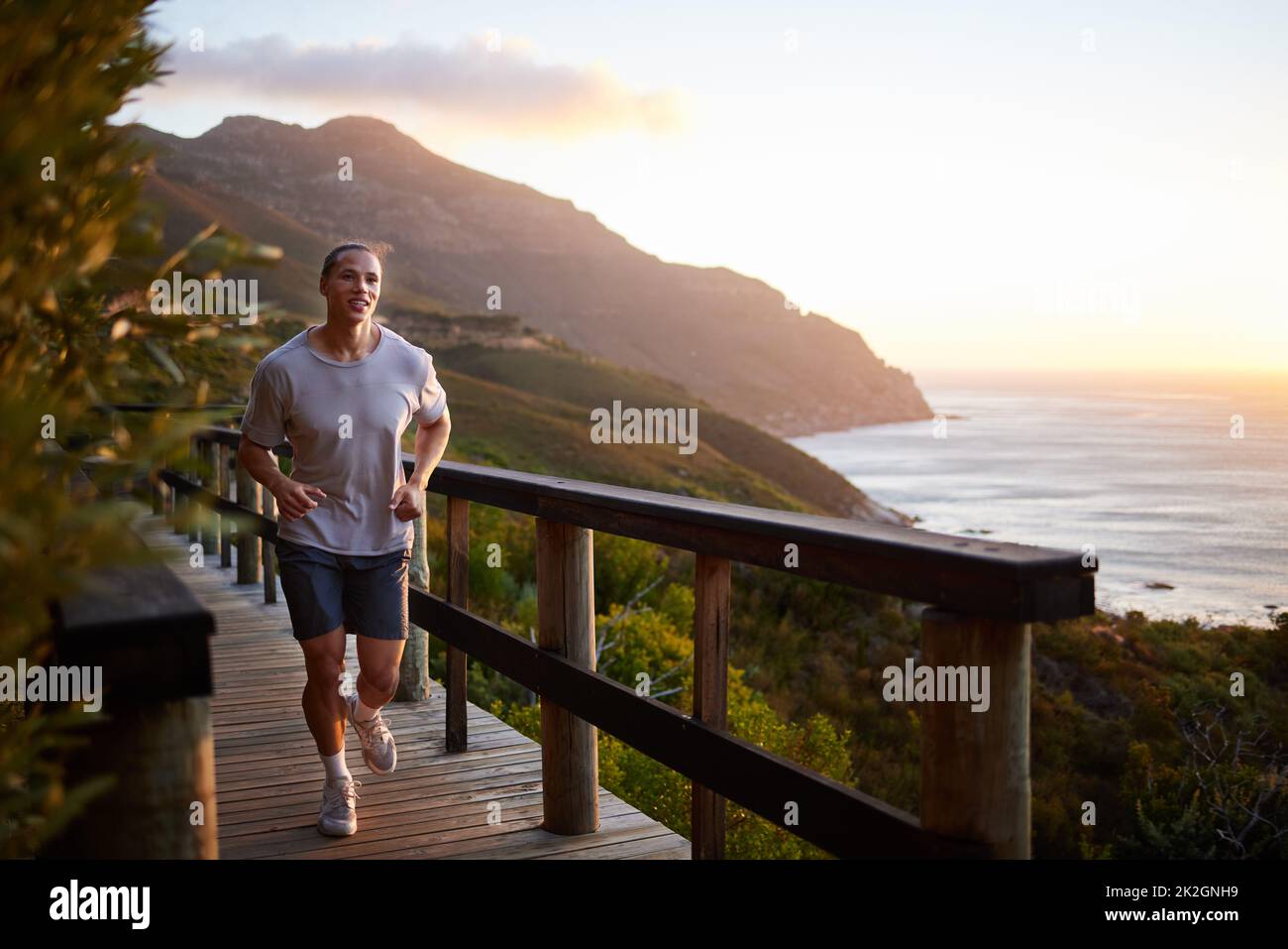 Cardio is good for the soul. Shot of a young man running alone outside ...