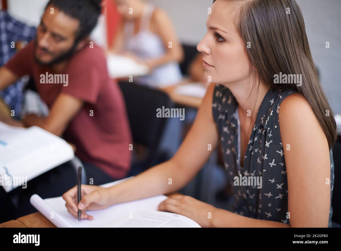 Going for an A. a group of young college students in class Stock Photo ...