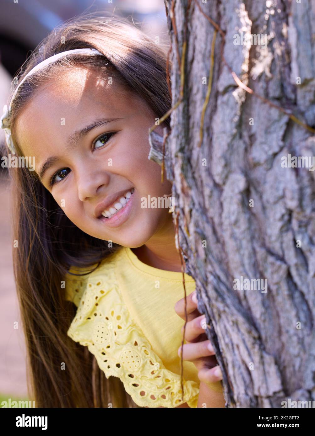 Girl Hiding Behind Tree
