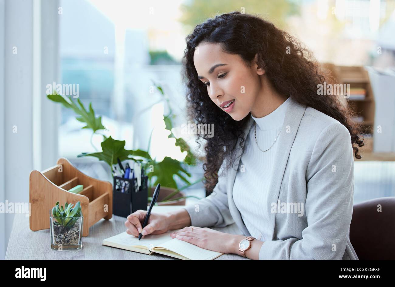 These notes will come in handy. Shot of a young businesswoman taking ...