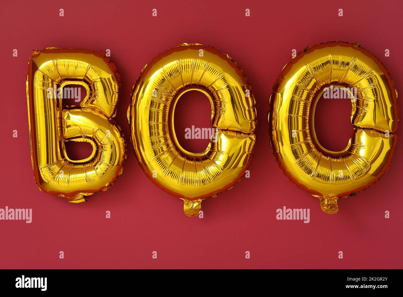Word BOO made of balloons on red wall. Halloween celebration Stock ...