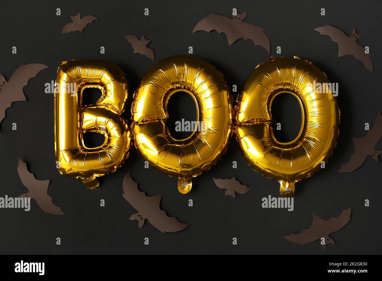 Word BOO made of foil balloons and paper bats on dark background Stock ...