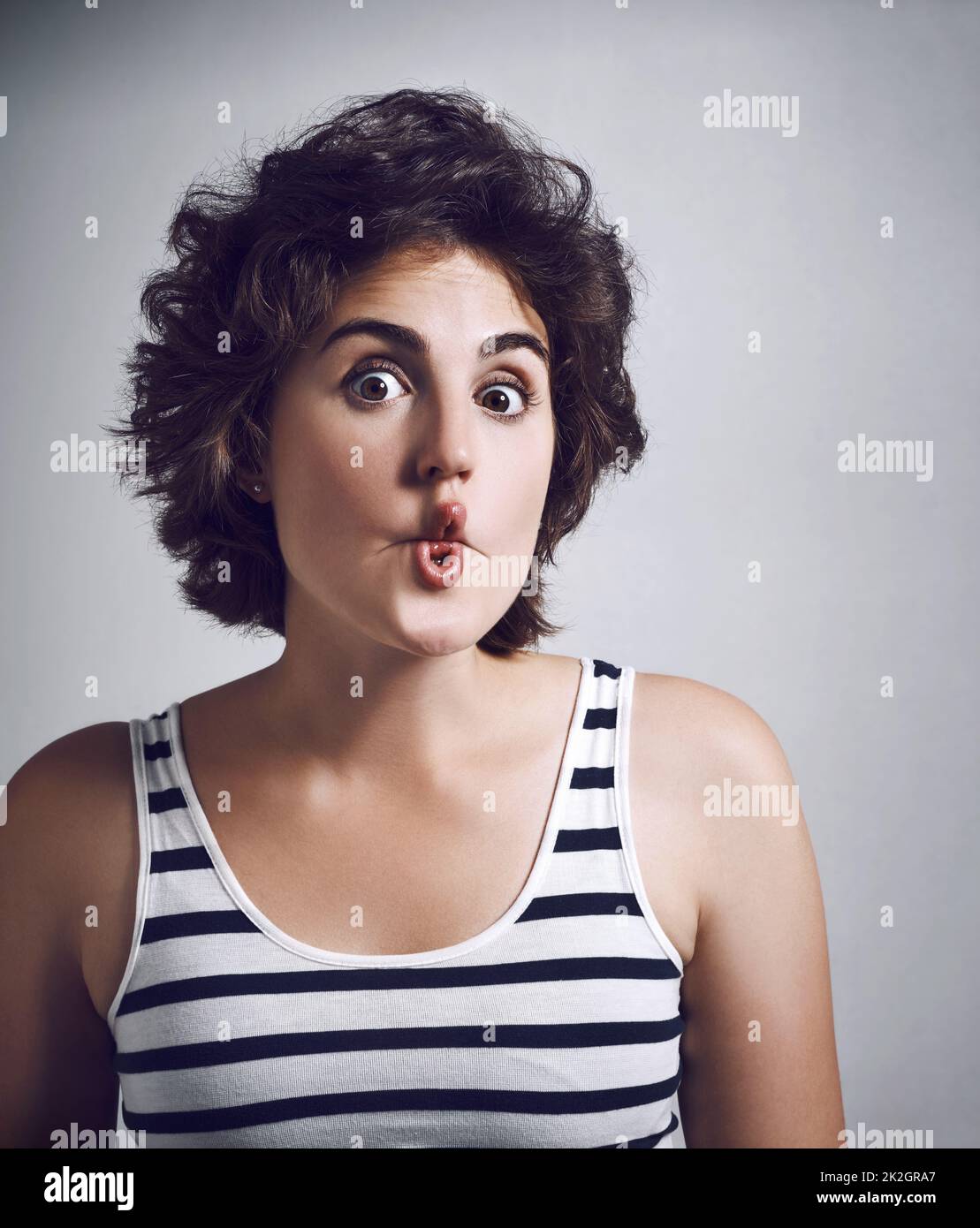 Its silly time. Studio portrait of an attractive young woman making a ...