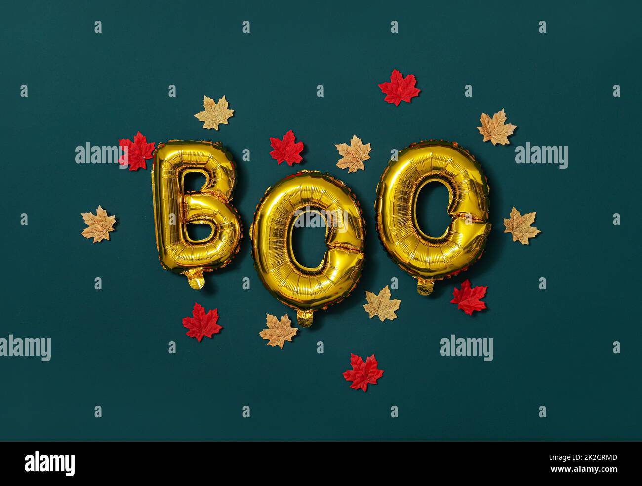 Word BOO made of balloons and fallen leaves on dark wall. Halloween ...
