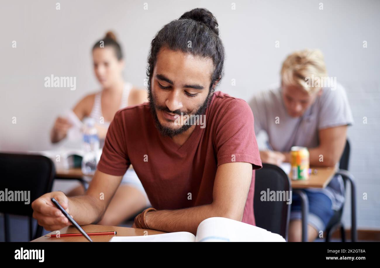 Aced this exam. a group of university students studying together Stock ...