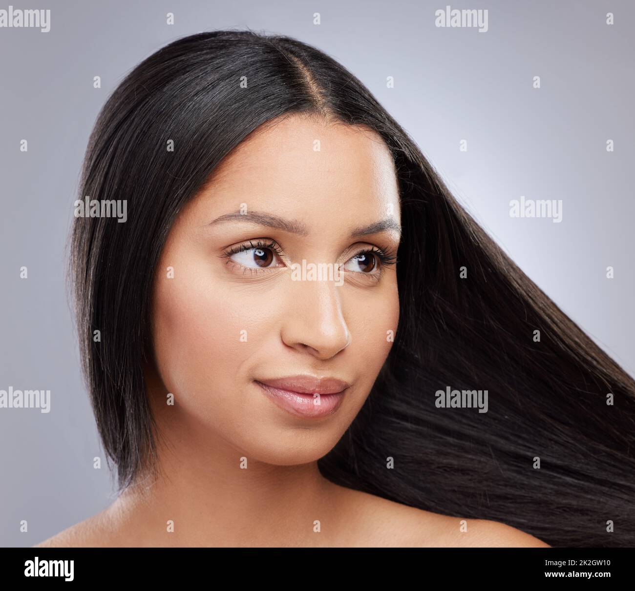 Showing off her healthy head of hair. Studio shot of a beautiful young ...