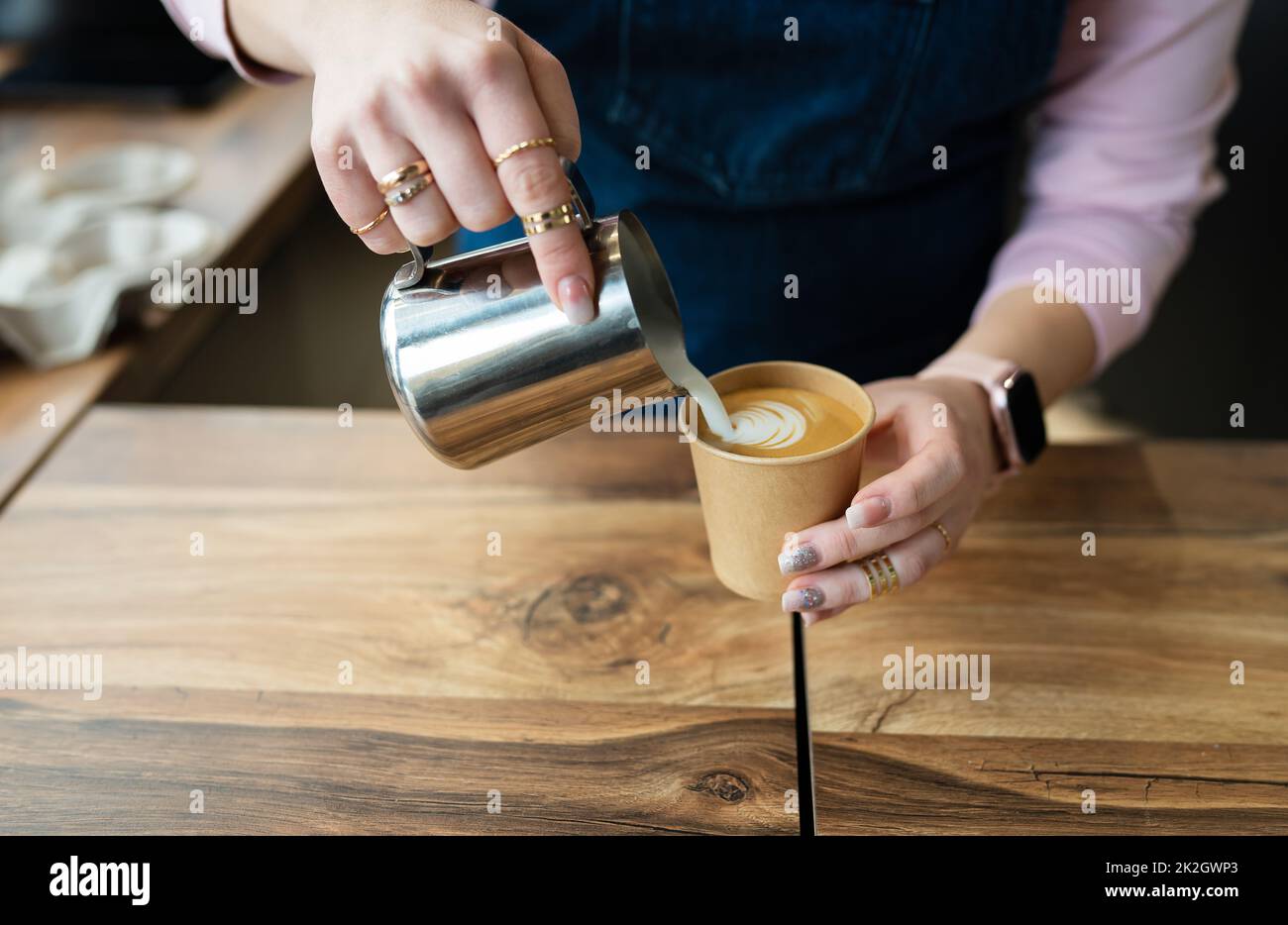 The process of making a barista cappuccino with a beautiful pattern on ...