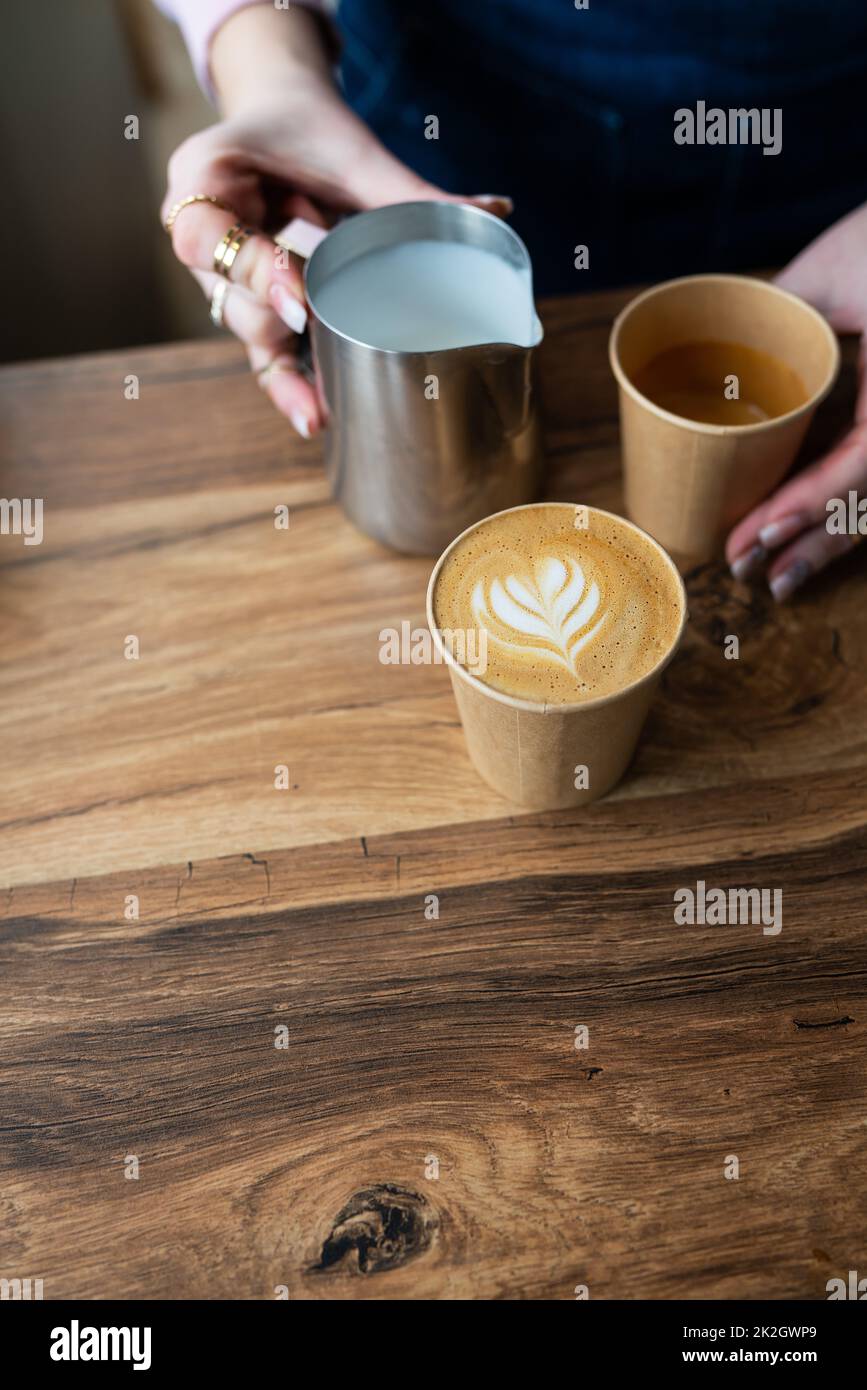 The process of making a barista cappuccino with a beautiful pattern on ...