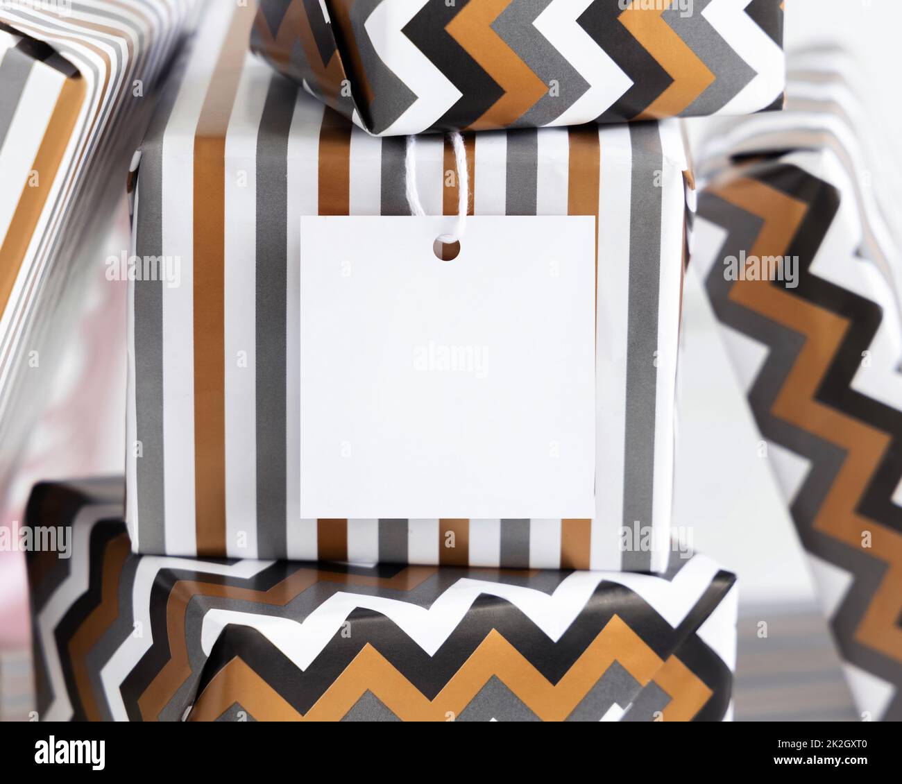 Wrapped present with blank square gift tag close up, label Mockup Stock ...