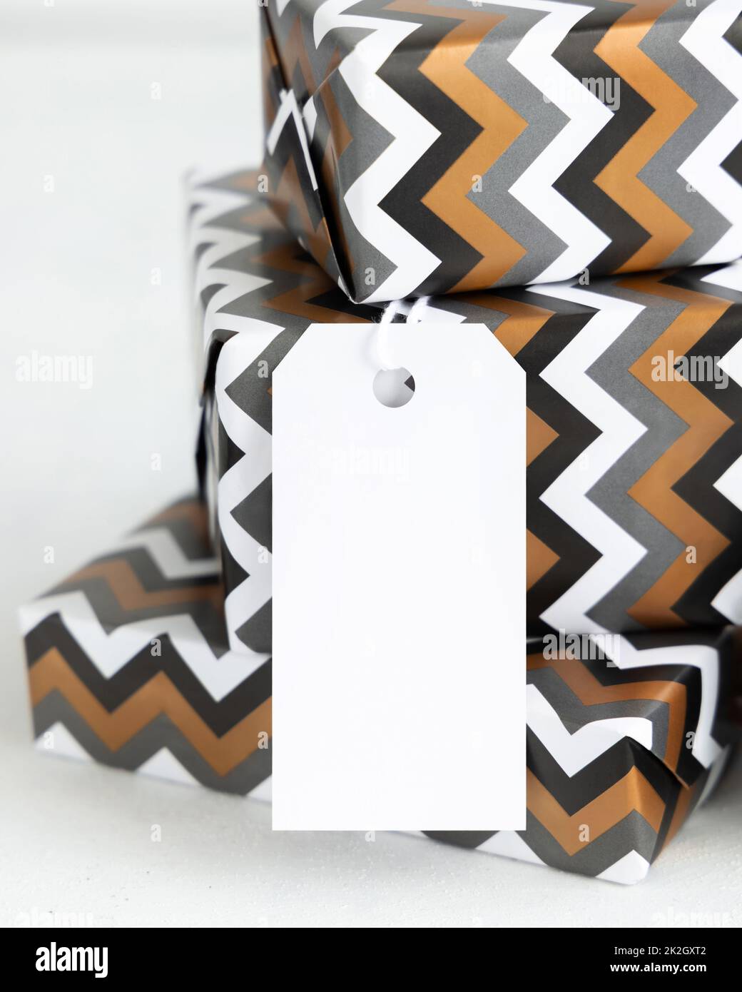 Presents Wrapped in chevron paper with blank gift tag close up, label ...