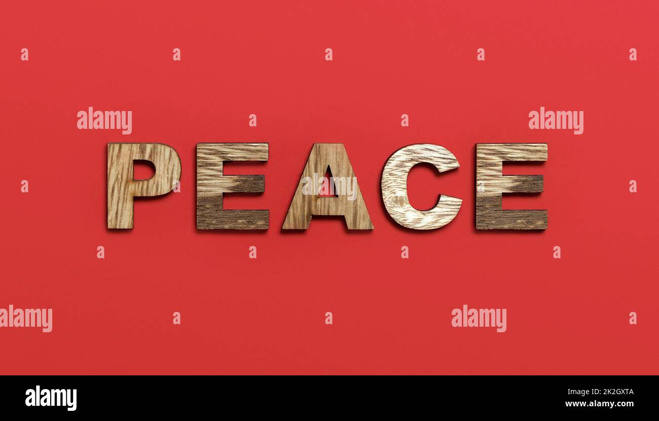Peace, word written in colorful wooden alphabet letters on red ...
