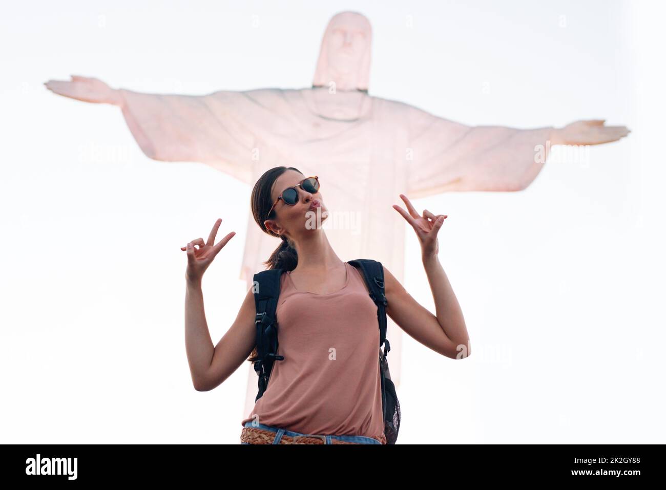 Feeling the Rio vibe. a woman posing for a picture in front of a statue ...