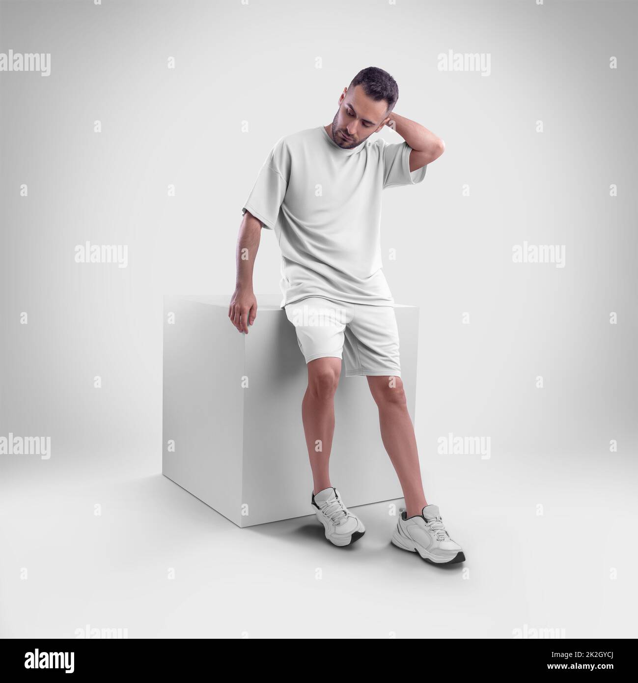 Mockup of white men's suit oversized t-shirt on shorts on man on cube ...