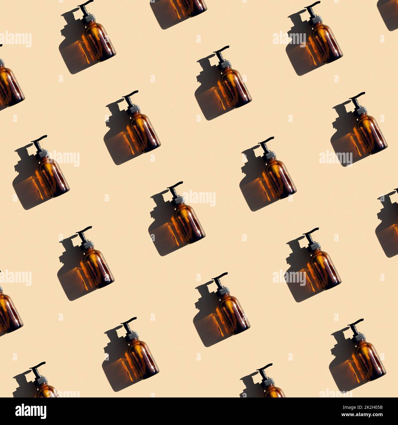 Pattern made with brown glass bottle with pump of cosmetic products and ...