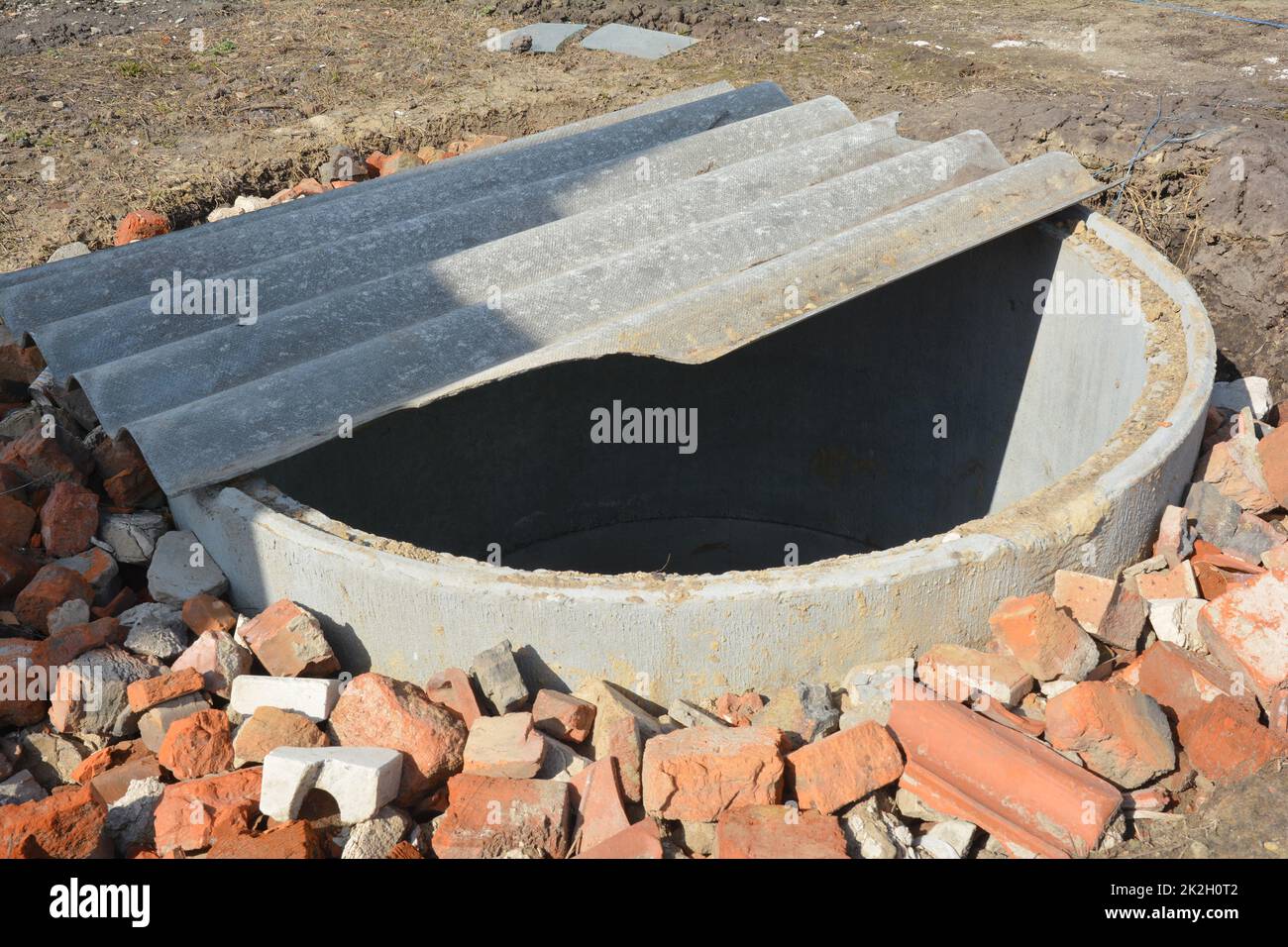 Installing concrete septic tank. Sewer tank hole installation outdoors ...