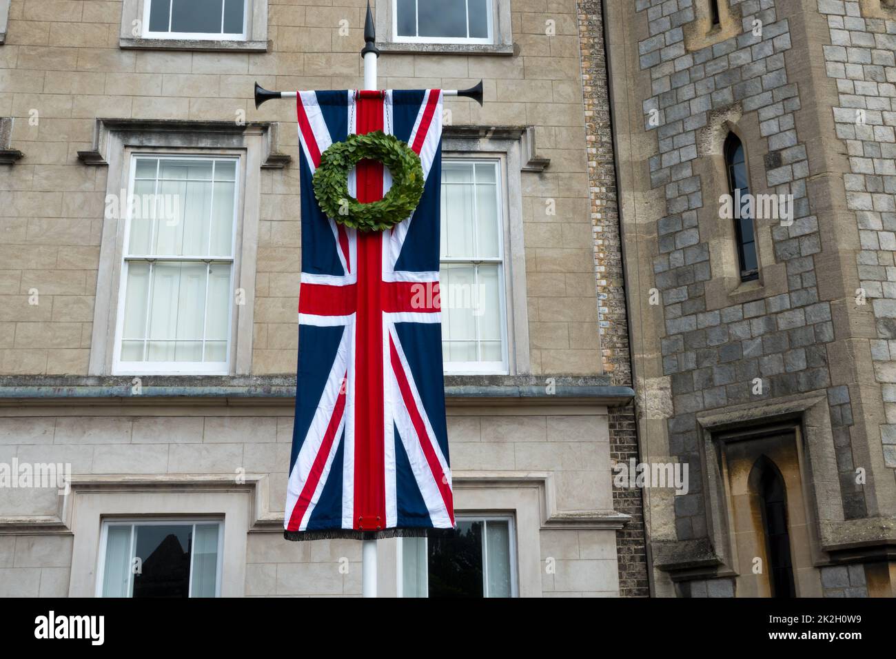Union Jack flag with a floral wreath hanging at a house close to ...