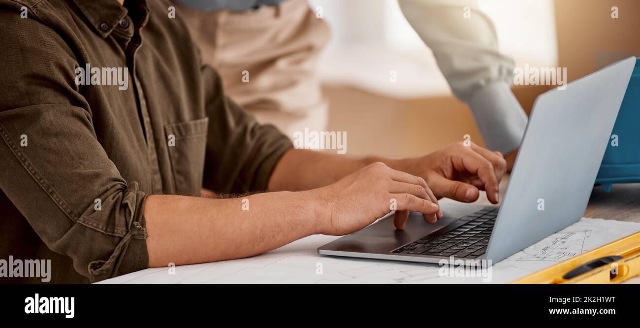 Lets work. Shot of two unrecognizable businesspeople working together in an office at work Stock ...