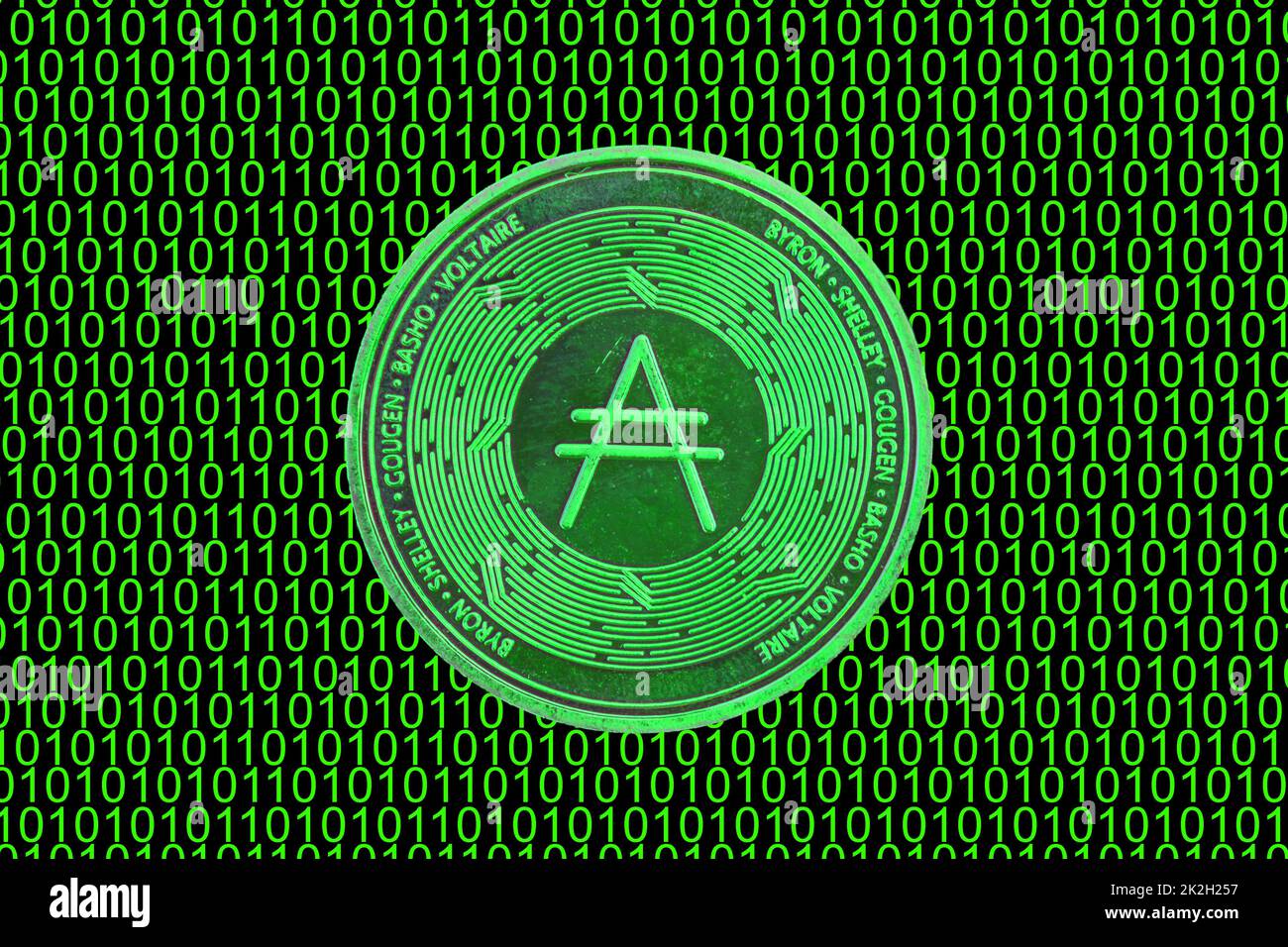 green binary code and a valueable green ada coin from cardano crypto ...