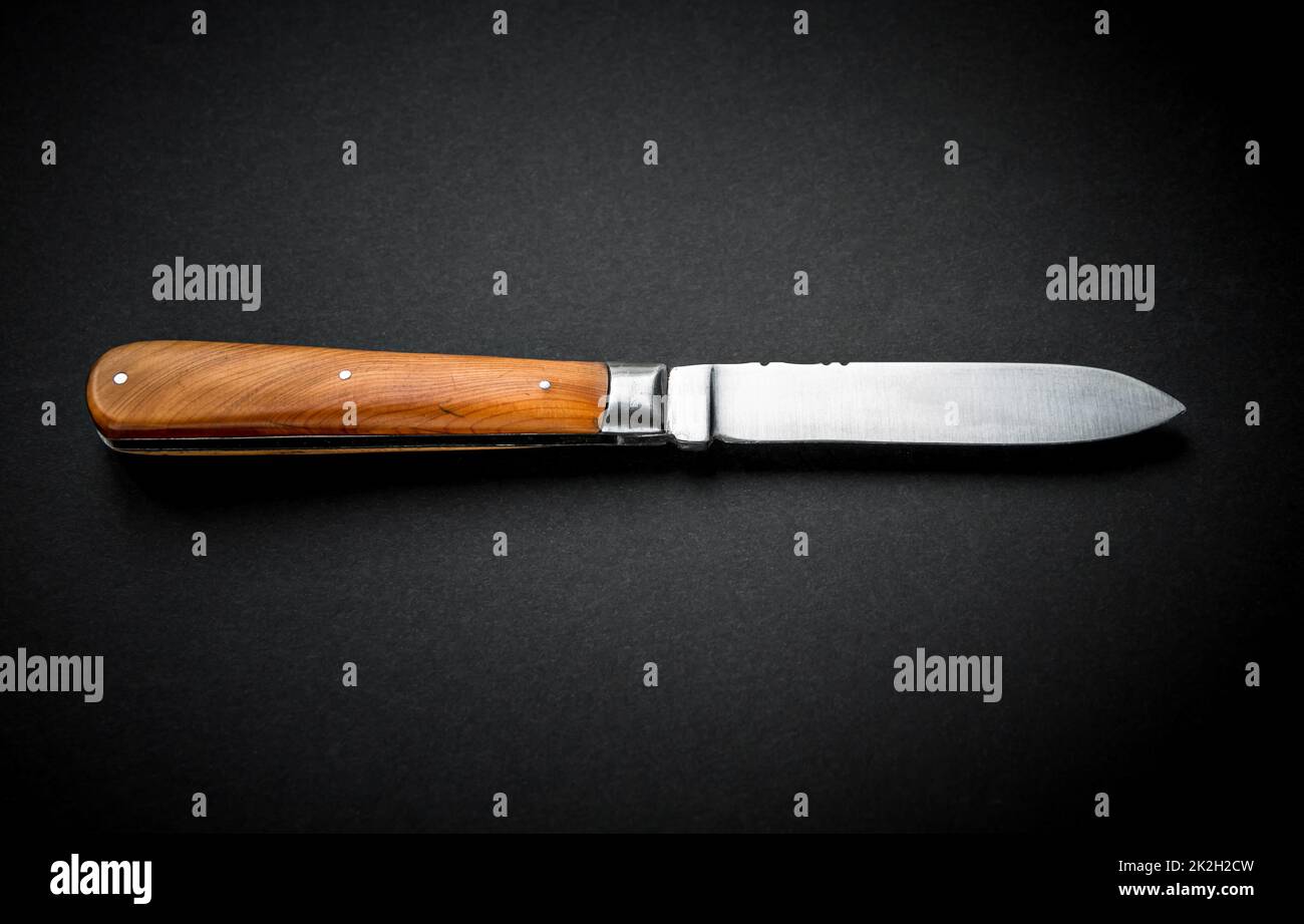 Traditional wooden pocket knife on black background Stock Photo - Alamy