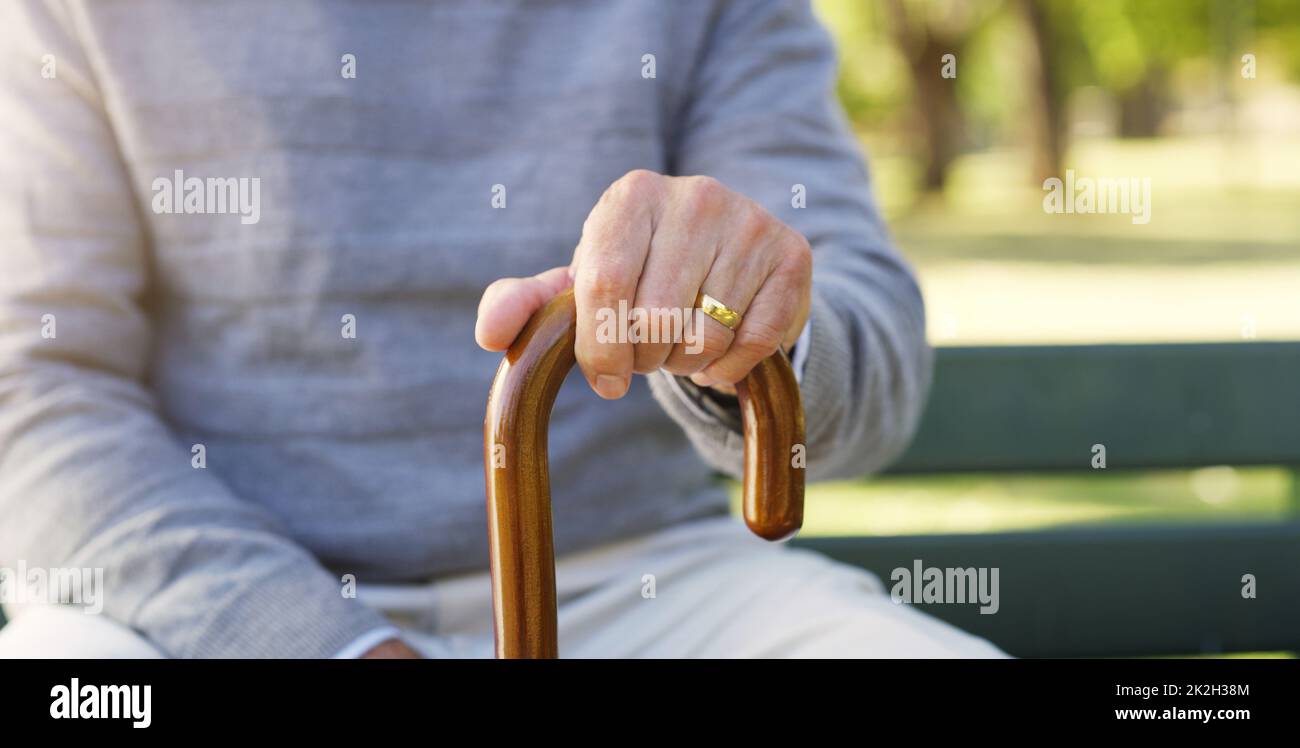 Old man holding walking stick hi-res stock photography and images - Alamy