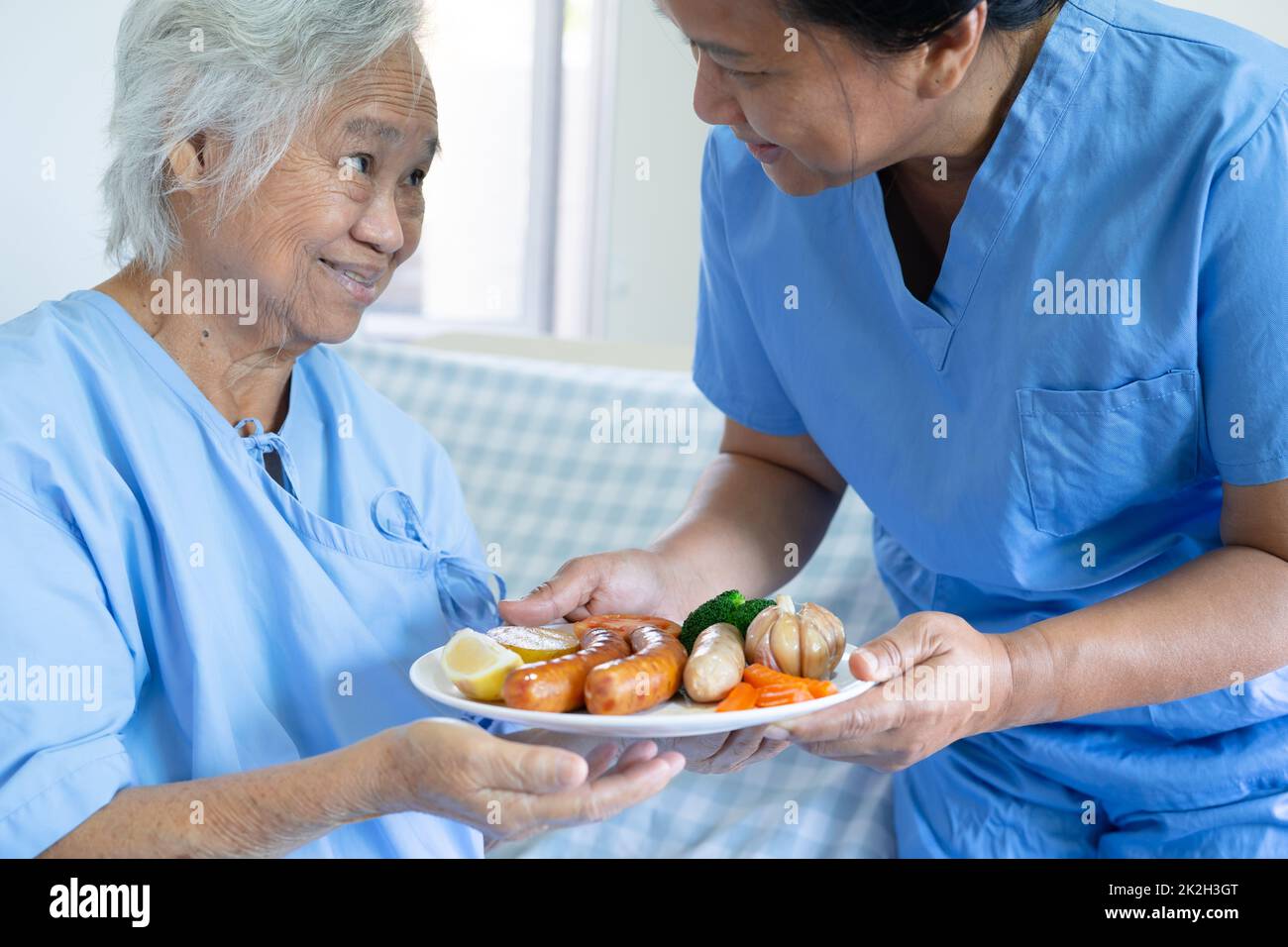 Asian senior or elderly old lady woman patient eating breakfast and ...