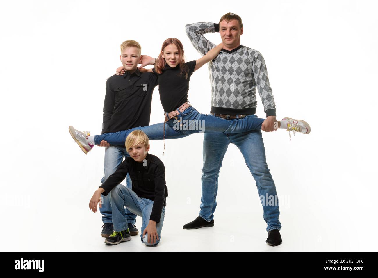 Dad And Son Hold Their Daughter On A Stretch The Second Son Sits Next