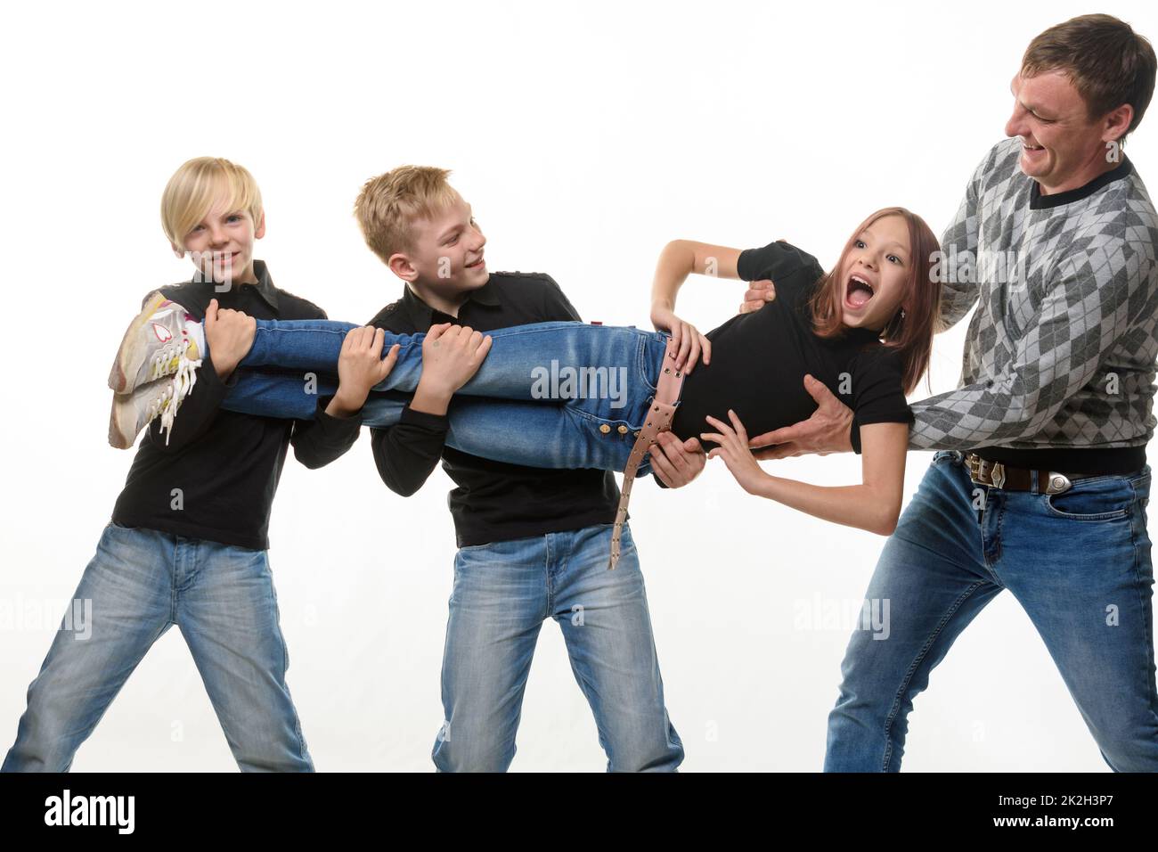 Dad and sons pull sister in different directions, white background ...