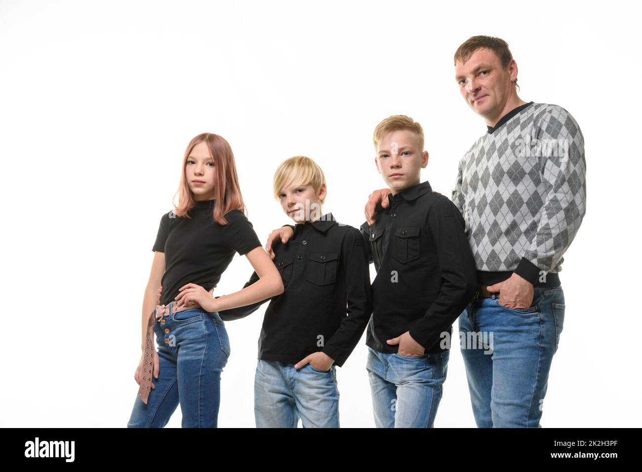 Dad, two sons and a daughter in casual clothes in dark colors, white ...