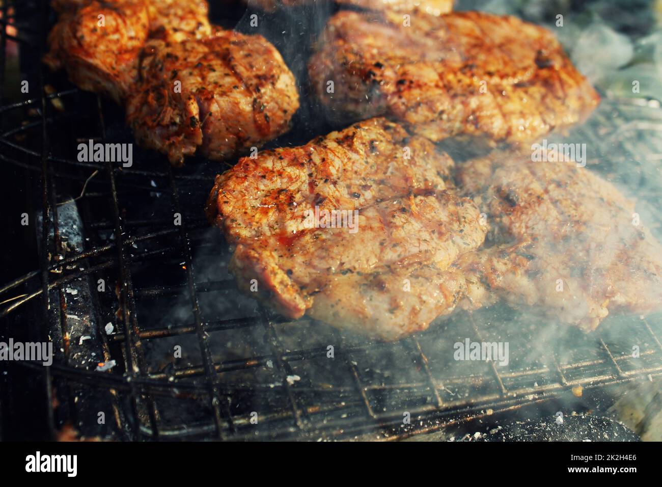 Grilled Steak BBQ with herbs. Barbecue Meat Steak outdoor on fire grill ...