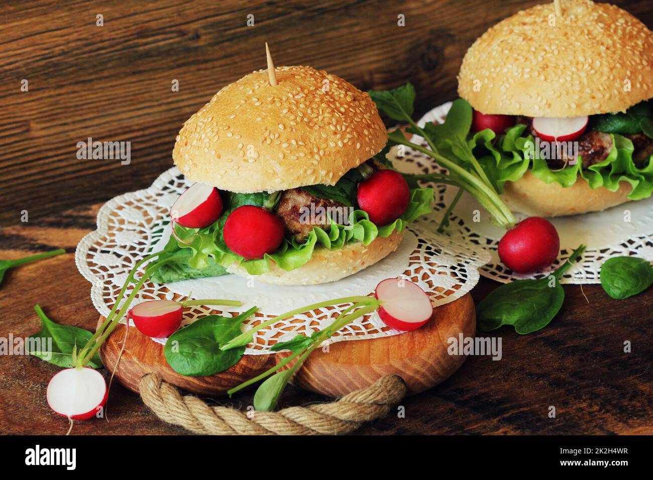 Homemade traditional burgers with beef,radish,lettuce, served on wooden ...